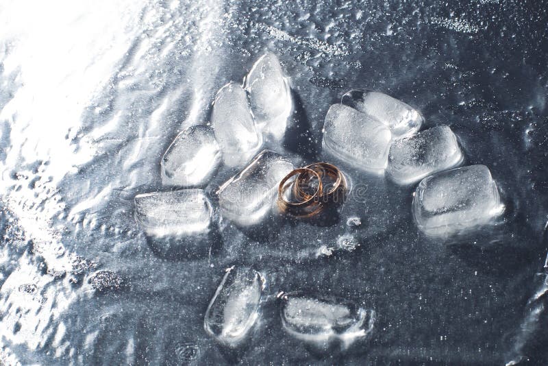 Wedding Rings with Splashes of Water and Pieces of Ice. Wedding Concept ...