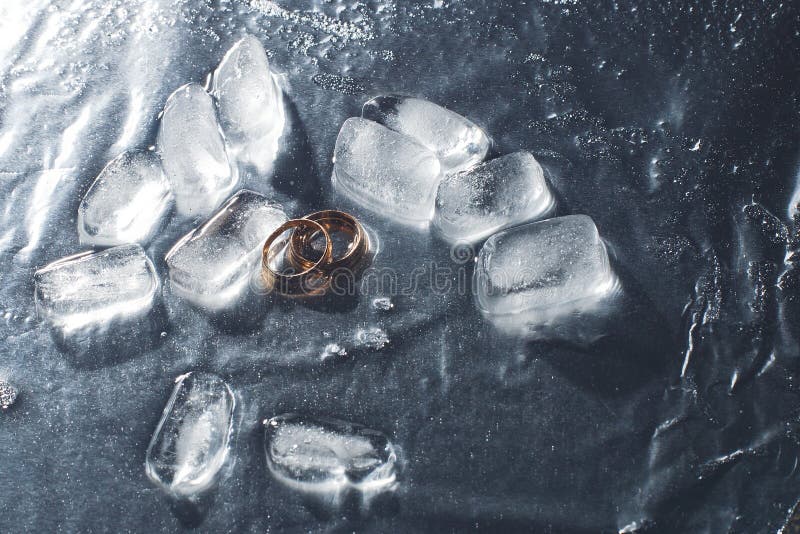 Wedding Rings with Splashes of Water and Pieces of Ice. Wedding Concept ...