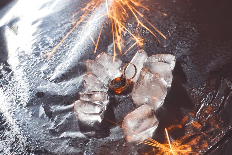 Wedding Rings with Splashes of Water, Pieces of Ice and Lights. Wedding ...