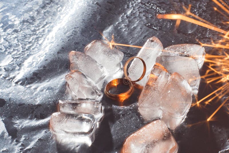 Wedding Rings with Splashes of Water, Pieces of Ice and Lights. Wedding ...