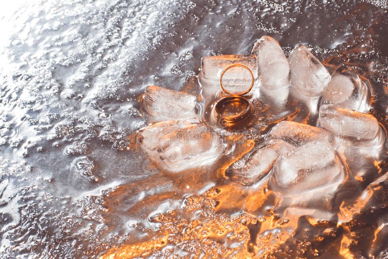 Wedding Rings with Splashes of Water, Pieces of Ice and Lights. Wedding ...
