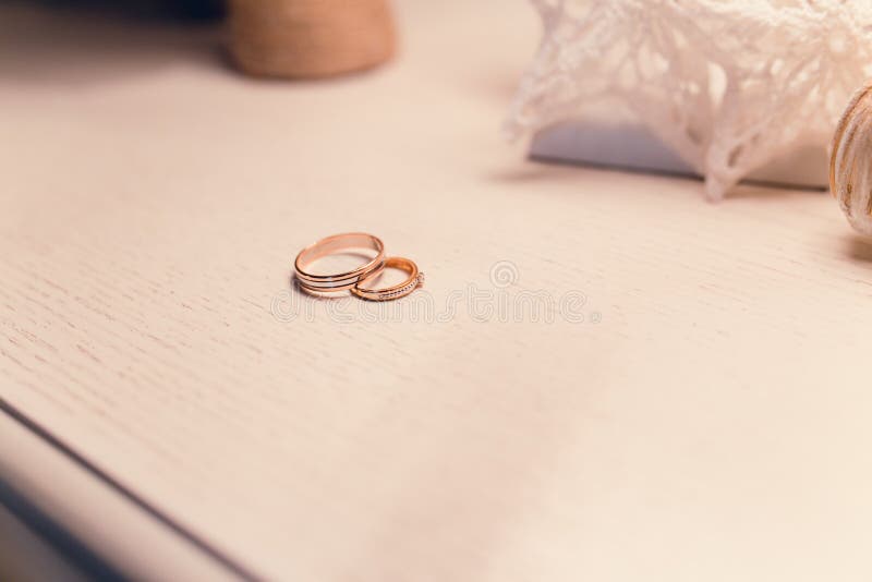 Wedding rings on the table stock image. Image of hand - 62217565
