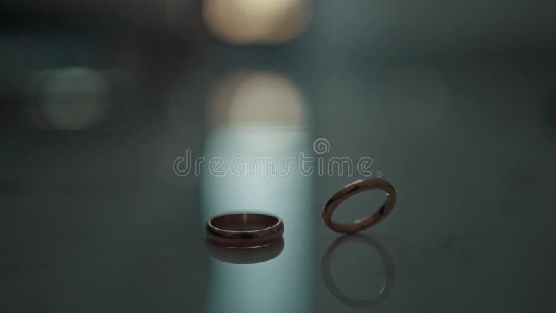 Wedding Rings on the Table. One Ring Rotates for a Long Time Stock ...