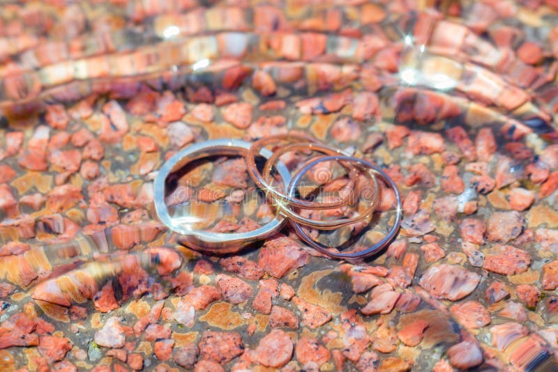 Wedding rings in the water stock photo. Image of white - 63325826