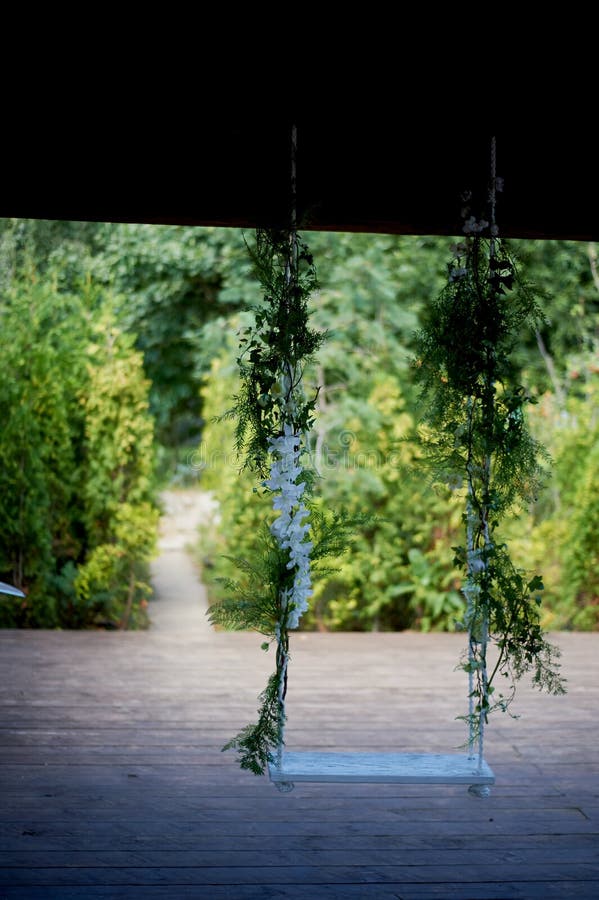 Wedding Swing Decorated with White Flowers Hanging on Tree in Garden ...