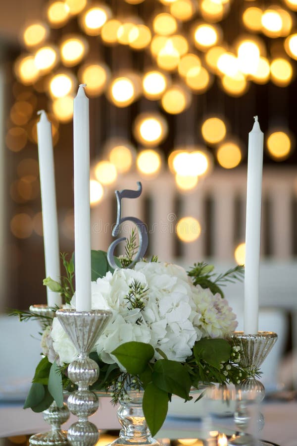 Wedding Table Setting is Decorated with Fresh Flowers and White Candles ...