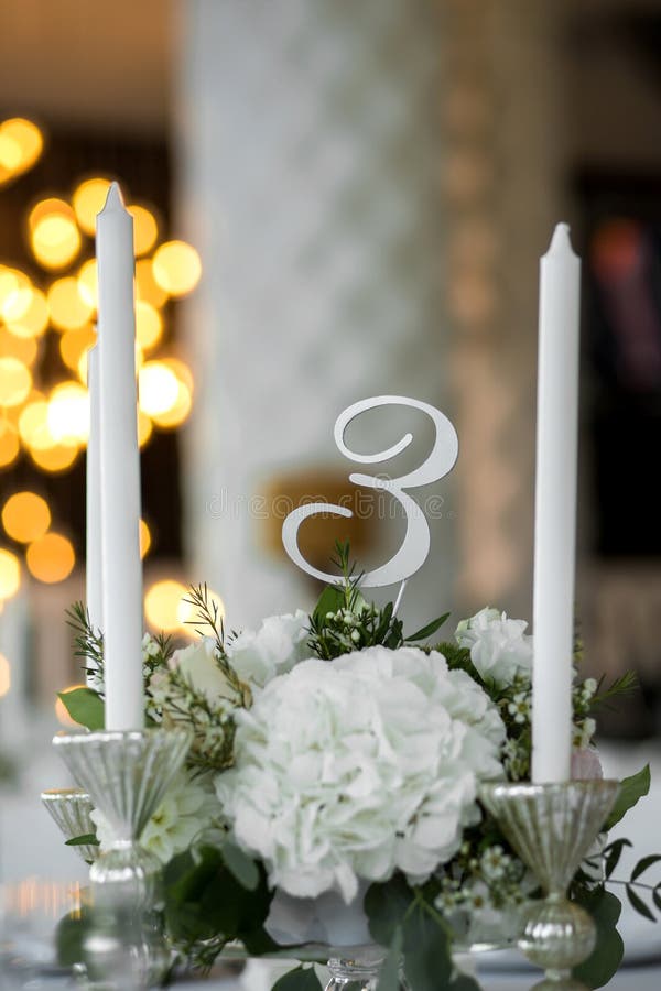 Wedding Table Setting is Decorated with Fresh Flowers and White Candles ...