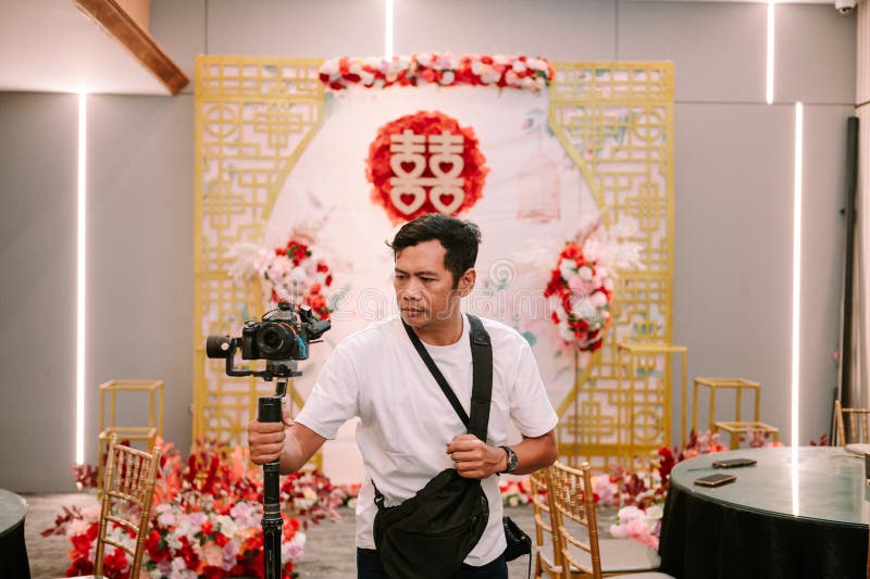 Wedding Videographer Filming Event with Camera on Stabilizer Indoors ...