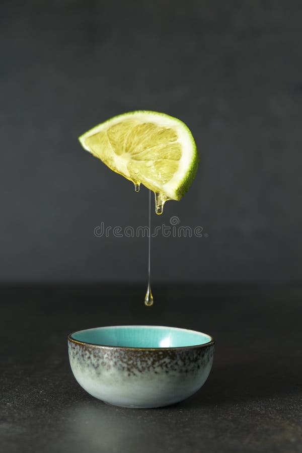 Wedge of Lime Hovers Over Small Bowl, Food Concept Stock Image - Image ...