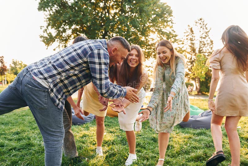Weekend Activities. Group of Young People Have a Party in the Park at ...