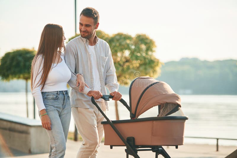 Weekend Walk. a Young Couple with a Baby Pram are Together Stock Image ...