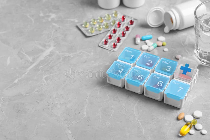 Weekly Pill Box with Medicaments on Grey Marble Table. Space for Text ...