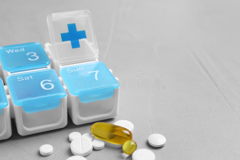 Weekly Pill Box with Medicaments on Grey Table, Closeup. Space for Text ...
