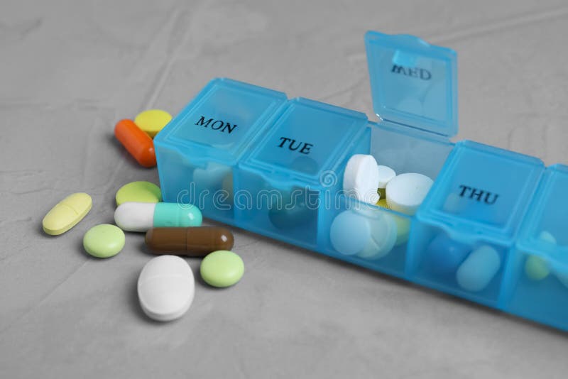 Weekly Pill Box with Medicaments on Grey Table, Closeup Stock Photo ...