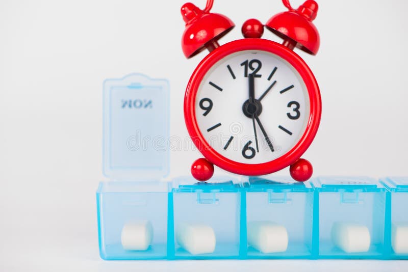 Weekly Pill Box and Red Clock Show Medicine Time Stock Photo - Image of ...