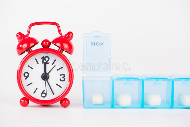 Weekly Pill Box and Red Clock Show Medicine Time Stock Image - Image of ...