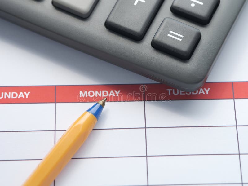 A Weekly Schedule with a Ballpoint Pen and a Calculator Lying on it ...