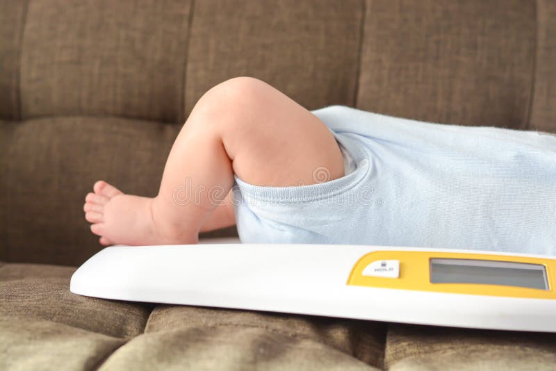 Weighing baby boy on scale stock photo. Image of clinic - 80913784