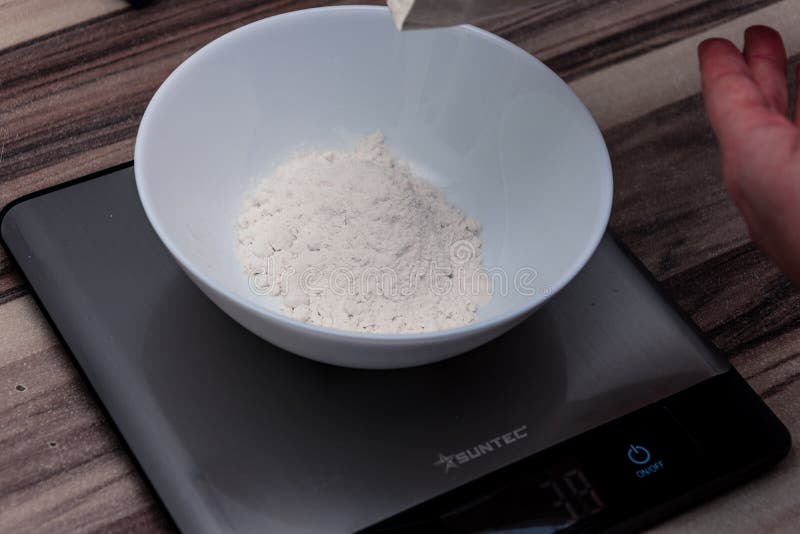 Weighing Flour for Baking with Professional Scales on the Table Stock ...