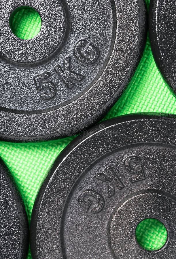 Weight Plates on a Black Rubber Floor Inside a Weight Training ...