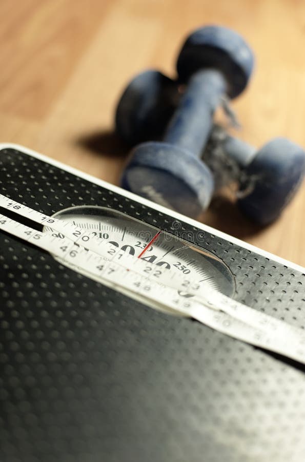 Midsection of Woman Smiling while Adjusting Weight Scale Stock Image ...