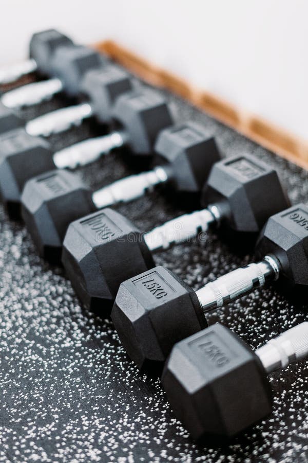 Weights in a row in a gym stock image. Image of dumbbells - 137843935