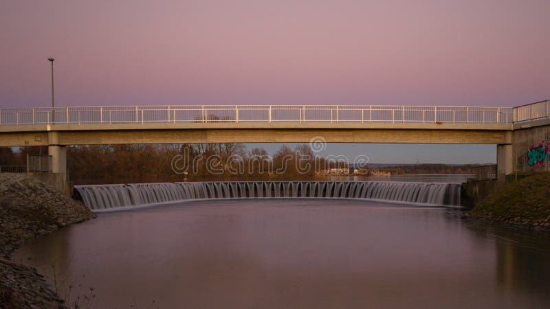Weir of lake during sunset stock photo. Image of human - 142885396