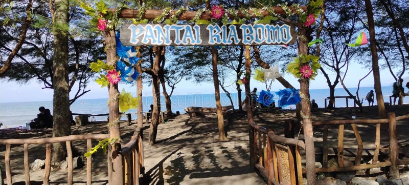 Welcome Gate from Ria Bomo Beach Editorial Photo - Image of beach, tree ...