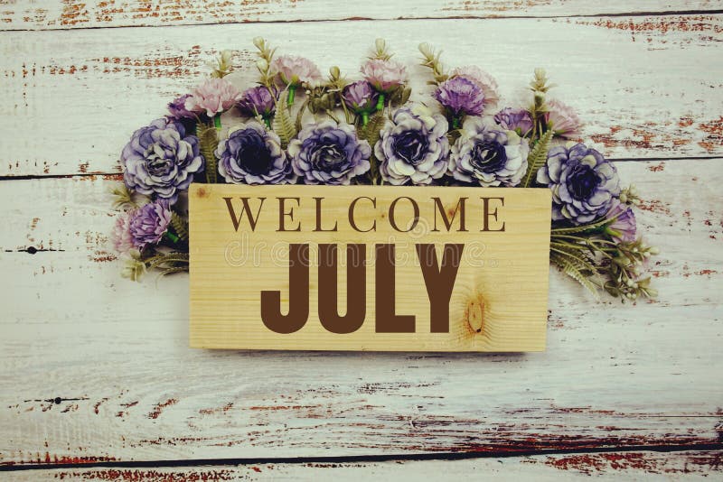Welcome July Text on Wooden Board with Flowers Frame on Wooden ...