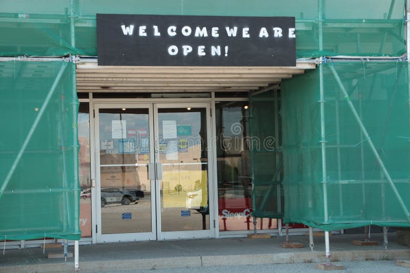Welcome we are Open Sign Above Store Doors Glass on Canopy Construction ...