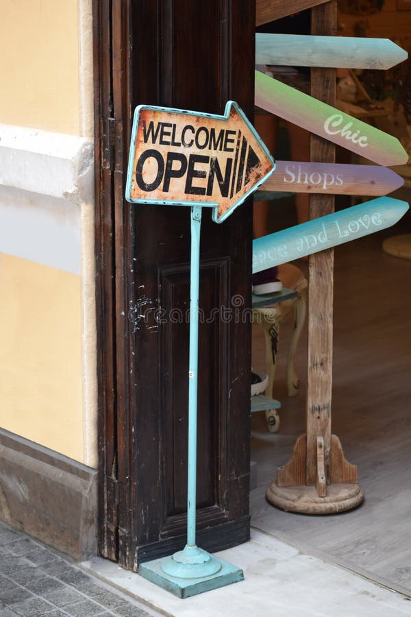 Welcome, we are open stock image. Image of signpost - 105300439