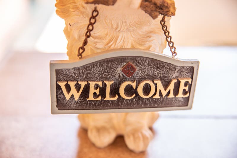 WELCOME . a Sign with the Inscription Welcome. Clay Cat Holds a Sign ...