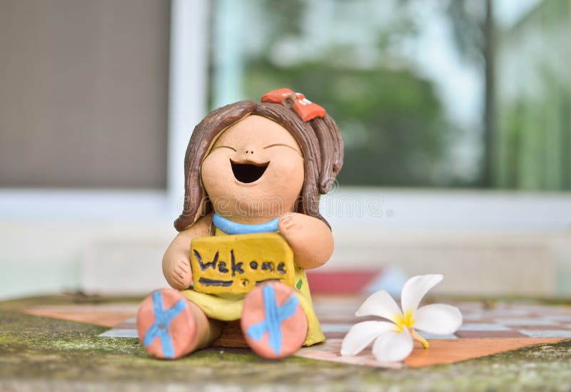 Welcome Sign Stone Doll with White Flower on the Table Stock Image ...
