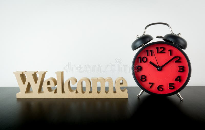 Welcome Signage with Red Alarm Clock on Table Stock Image - Image of ...