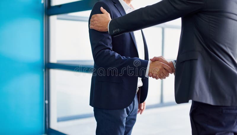 Welcome. Two Businessmen Shaking Hands in the Lobby. Stock Image ...