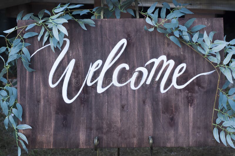 Welcome Wooden Sign Board with Rope Hanging in Front of the Gate Stock ...