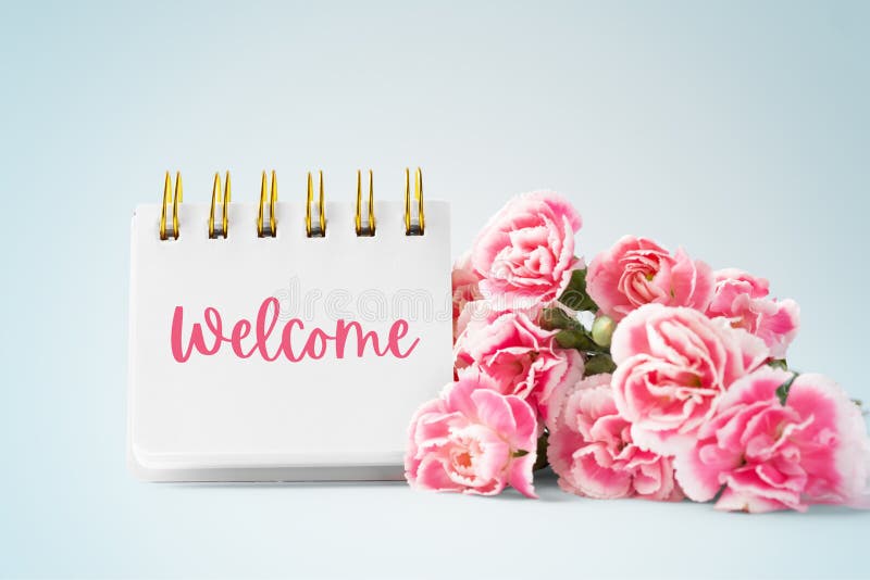 Welcome Word on Notebook and Carnation Flowers on Blue Background Stock ...