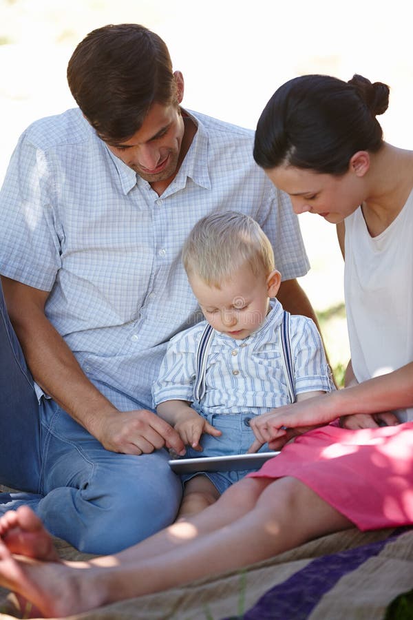 Welcoming Him To the Digital World. a Family Using a Digital Tablet ...
