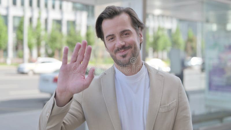 Welcoming Young Man Waving Hand for Hello Outdoor Stock Image - Image ...