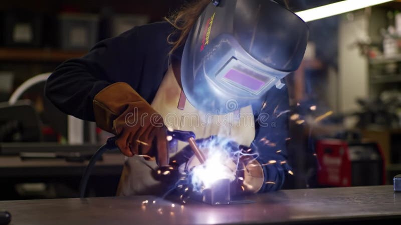 Welder Creating Precision Metal Joints in Workshop during Evening Hours ...