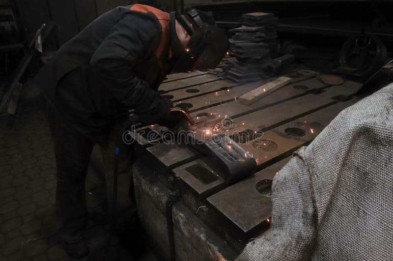 The Welder is Engaged in Performing Welding Work with the Help of ...