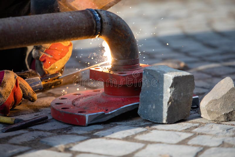 The Welder Fastens the Rusty Pipes Using a Special Tool Stock Photo ...