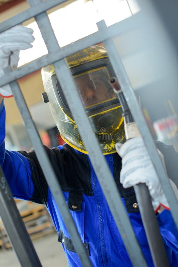 Welder with frame stock photo. Image of gloves, uniform - 261516072
