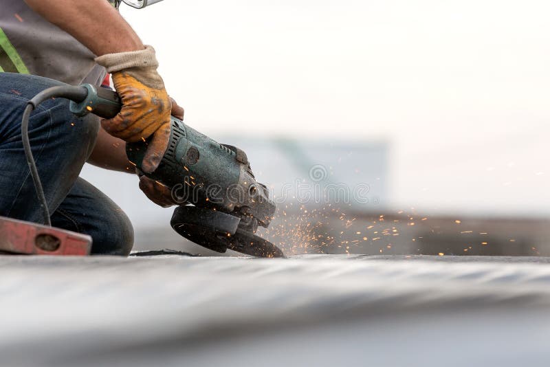 Welder is Grinding the Welding of Large Pipe. Grinding is an Abrasive ...