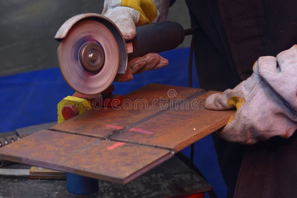 Welder Hands Grinding Metal Piece with a Grinder, Processing Weld after ...