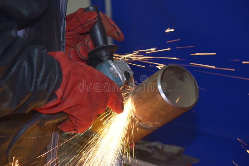 Welder Hands Grinding Metal Piece with a Grinder, Processing Weld after ...