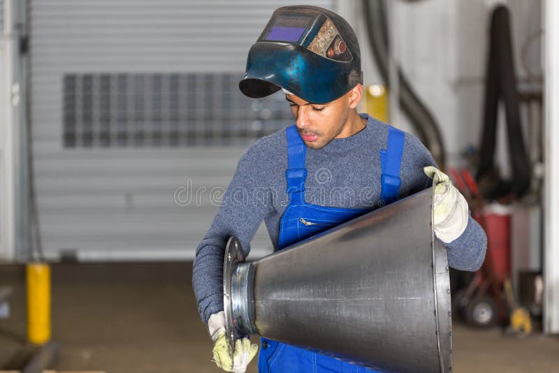 Welder Inspecting Metal Piece for Quality Control Stock Photo - Image ...