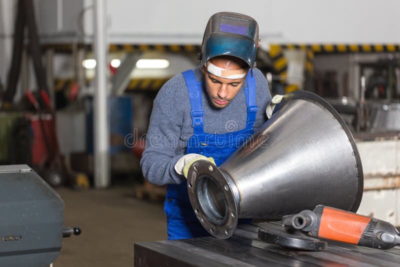 Welder Inspecting Metal Piece for Quality Control Stock Image - Image ...