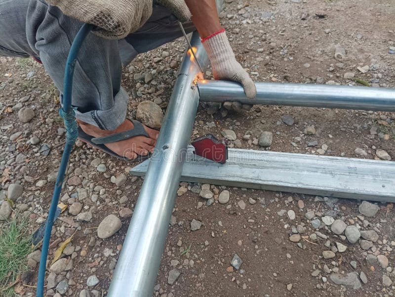 Welder Joining Metal Pipes with Welding Machine Outdoors. Metalwork ...