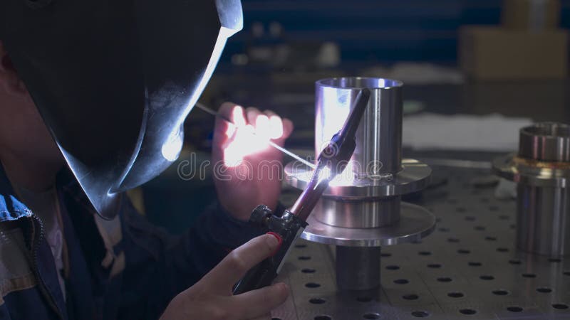 A Welder Makes a Precision Weld on a Stainless-steel Element. the ...